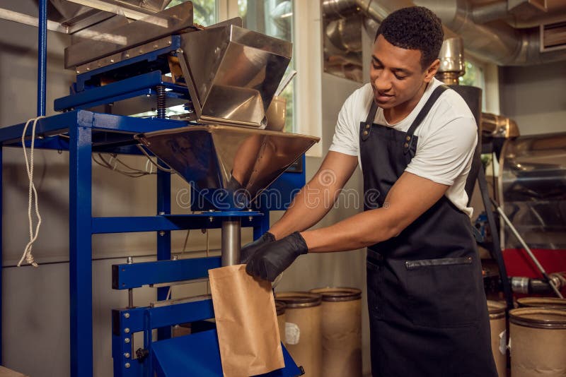 Employee Working on the Modern Packaging Equipment in the Roastery ...
