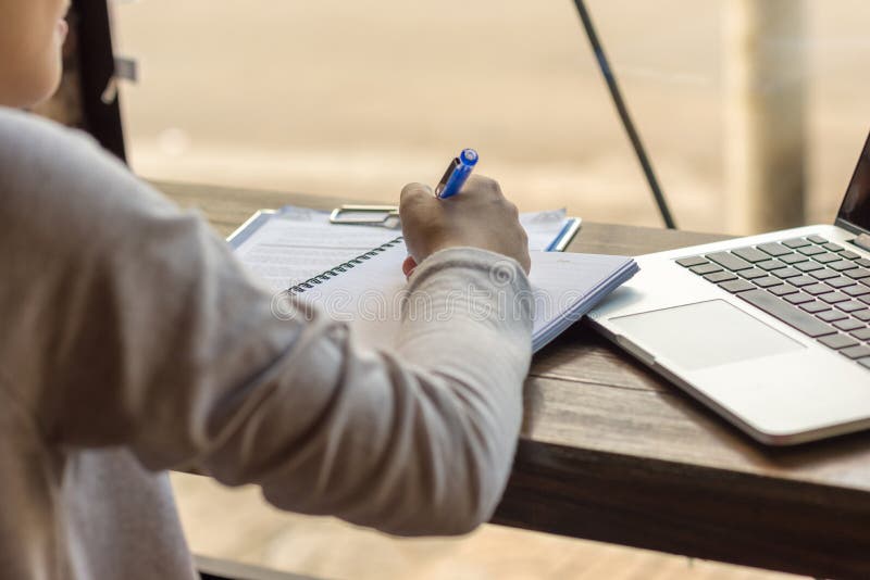 Employee Writing Information from Reports To Notebook Stock Photo ...