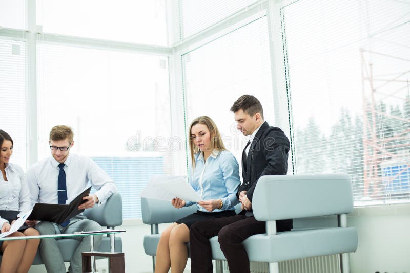 Employees of the Company with Documents Sitting in the Reception Room ...