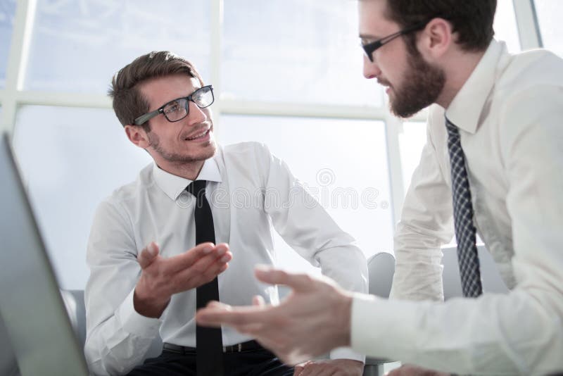 Employees Discuss Something Sitting in Front of an Open Laptop. Stock ...