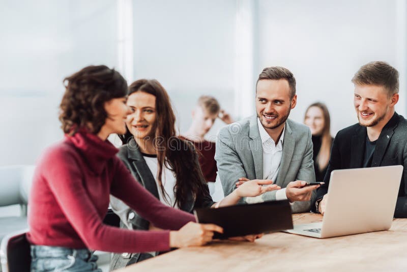 Employees Discuss Working Documents Sitting at a Desk Stock Photo ...