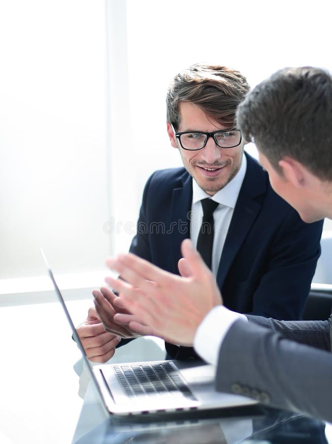 Employees Discussing Online Information Sitting at the Office Desk ...