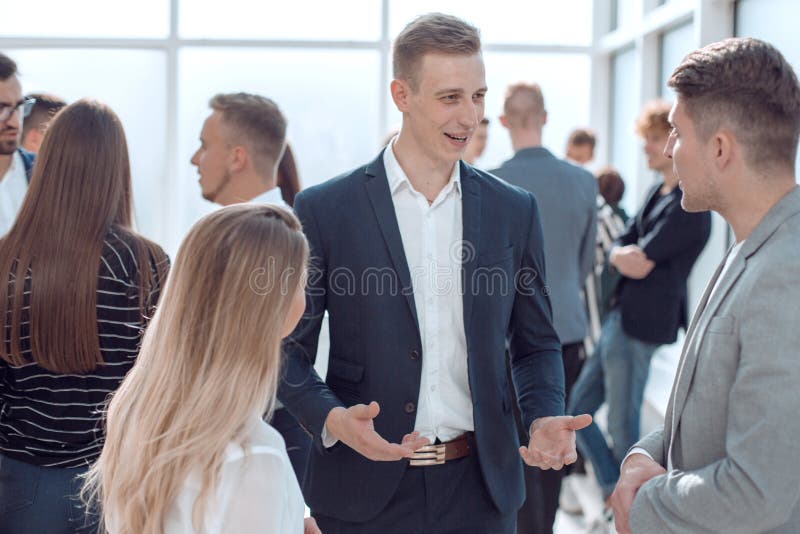 Employees Discussing Their Ideas Standing in the Office Corridor Stock ...