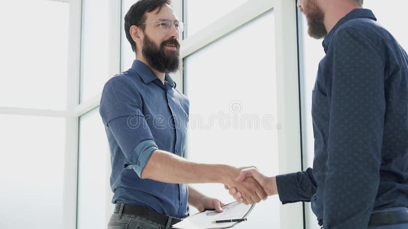 Employees Greeting Each Other with a Handshake and Discussing Work ...