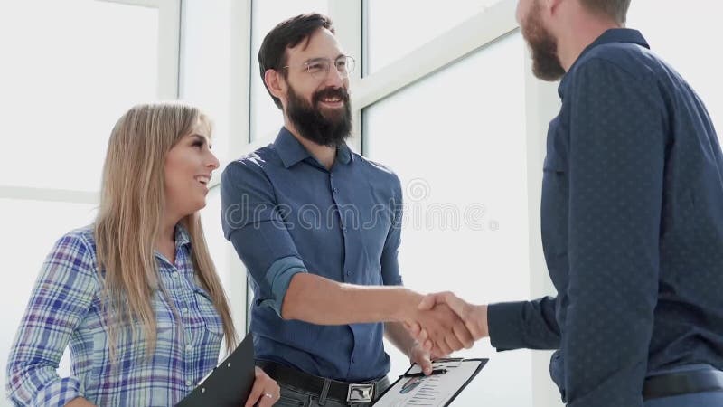 Employees Greeting Each Other with a Handshake in the Office. Stock ...