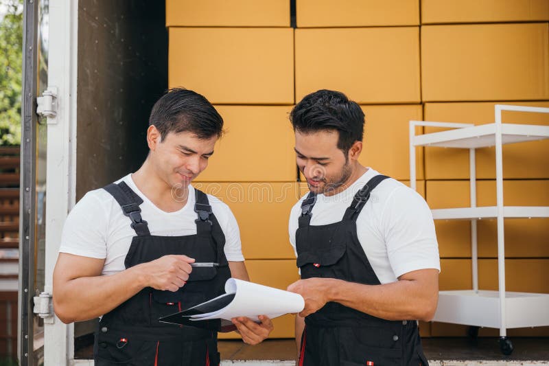 Employees Outdoors Unloading Boxes and Checking Documents for the ...