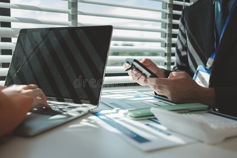 Employees Sit in an Office with a Pile of Documents that Need To Be ...
