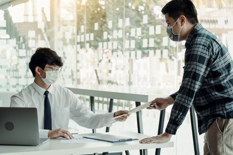 Employees Submit Documents at Their Office while Wearing Masks during ...