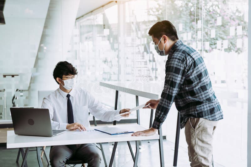 Employees Submit Documents at Their Office while Wearing Masks during ...