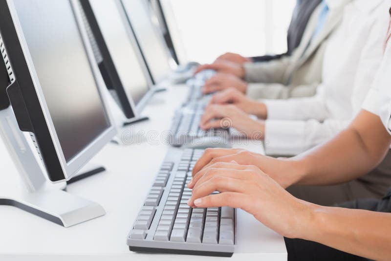 Employees Typing on Their Computers Stock Photo - Image of smiling ...
