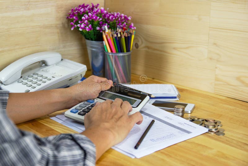 Employees Use Office Calculators with Documents of Income, Expenses ...