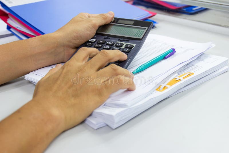 Employees Use Office Calculators with Documents of Income, Expenses ...