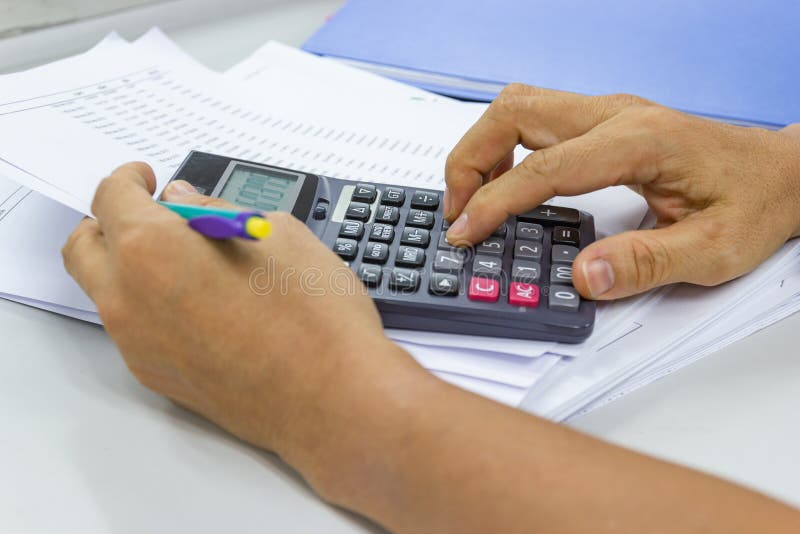 Employees Use Office Calculators with Documents of Income, Expenses ...