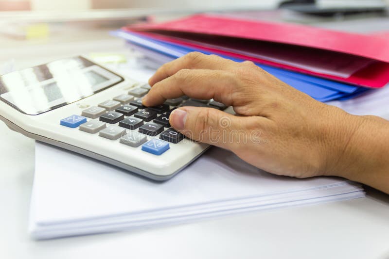 Employees Use Office Calculators with Documents of Income, Expenses ...
