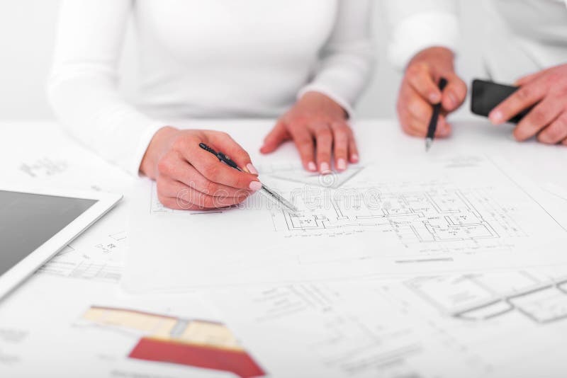 Employees Work on Blueprints or Engineering Plans in the Office ...