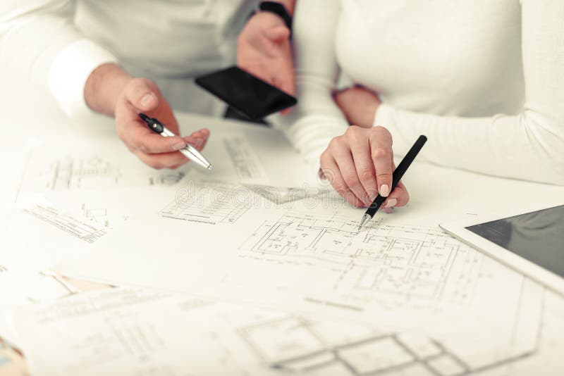 Employees Work on Blueprints or Engineering Plans in the Office ...