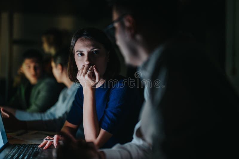 Business Coworkers Engaged in a Serious Discussion during Late Office ...