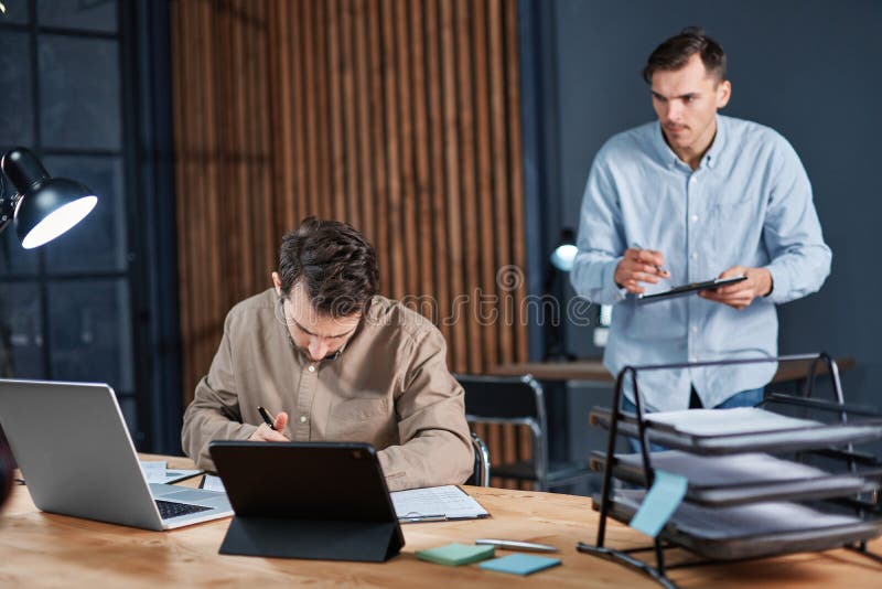 Employees Working with Documents until Late at Night. Stock Photo ...