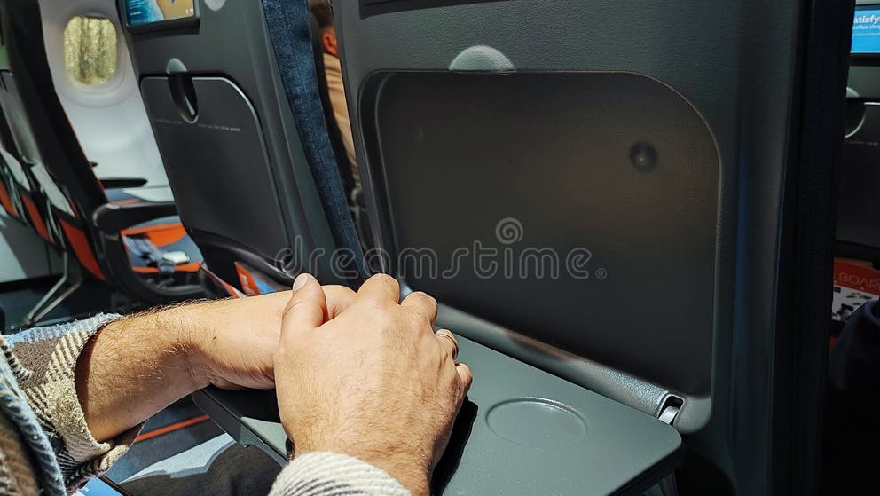 Empty Airplane Cabin. Male Hands on the Table in the Airplane Cabin ...