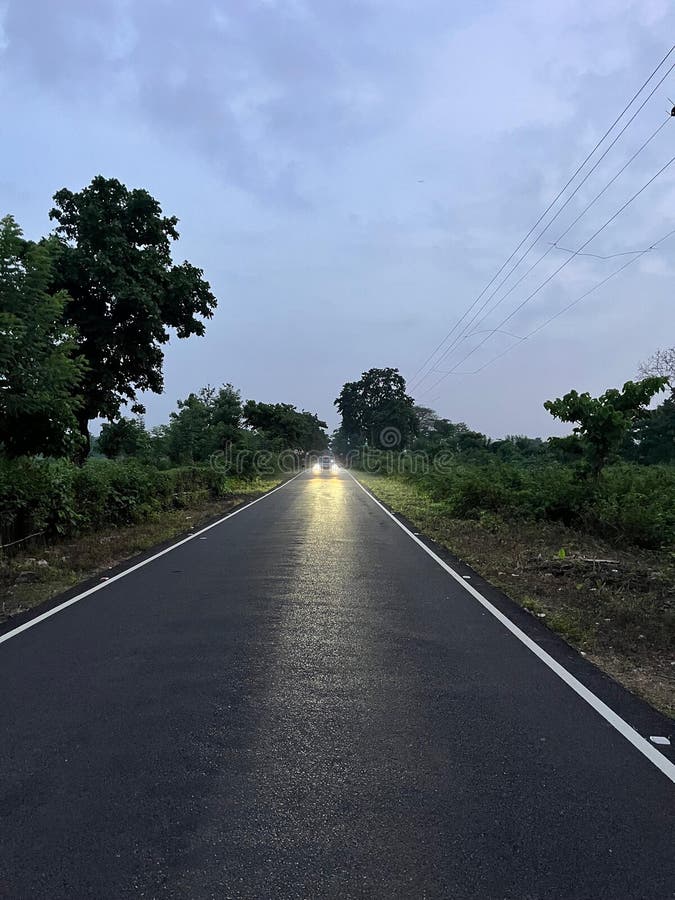 Empty Asphalt Road at Dusk with Headlights in a Scenic Countryside ...