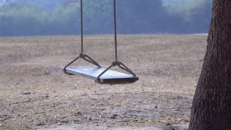 Empty Baby Swings at a Park Swinging from the Wind Stock Footage ...