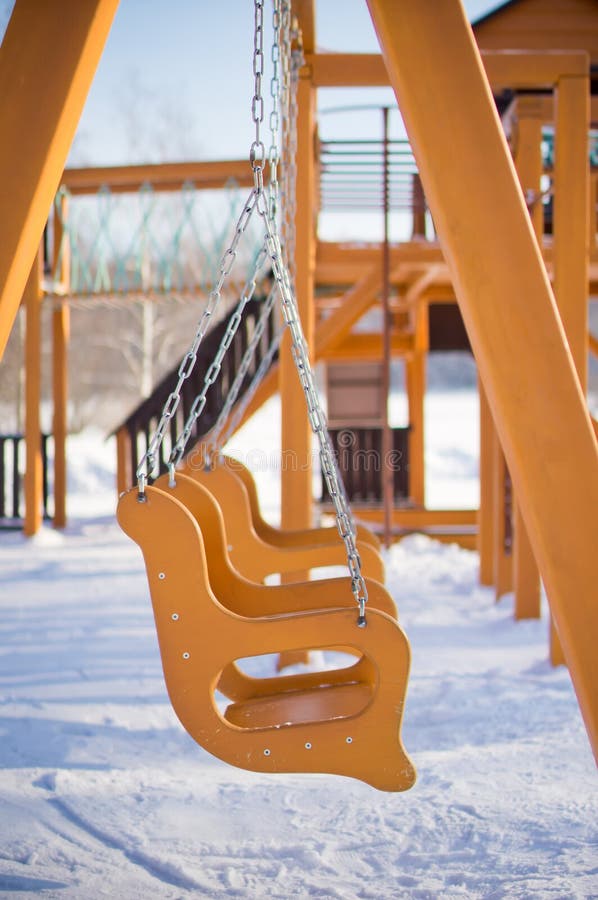 Empty Baby Swings on Playground Stock Image - Image of snow, wooden ...