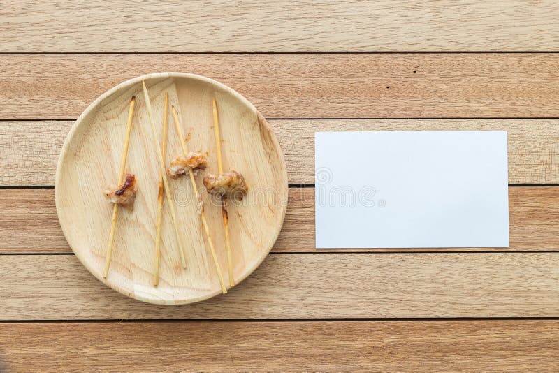 Empty Bamboo Stick of Grilled Pork and Paper Note on Wooden Dish Stock ...