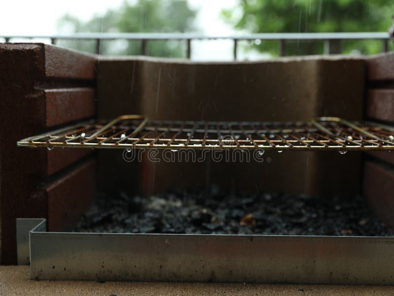 Empty Barbecue Grill with Grid Under Rain Outdoors, Closeup Stock Photo ...