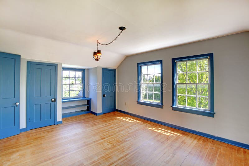 Empty Basement Room Interior with Blue Doors and Hardwood Floor. Stock ...