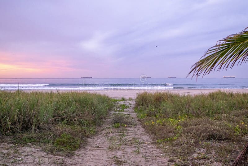Empty Beach at Sunset with Cargo Ship in the Horizon Stock Photo ...
