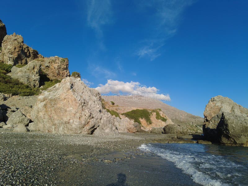 Empty Beautiful Beach with Rocks and Mountains in Background Stock ...