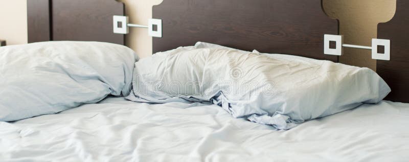 Disheveled Sheets and Pillows of an Unmade Bed Stock Photo - Image of ...