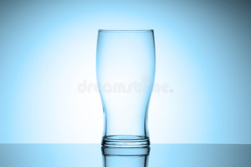Empty Beer Glass Stands on a Glossy Table with Reflection. Cold Blue ...