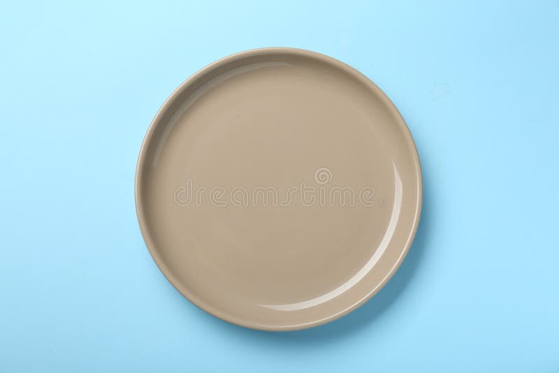 Empty Beige Ceramic Plate on Light Blue Background, Top View Stock ...