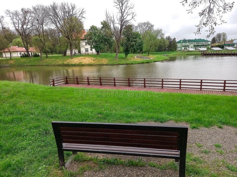 An empty bench in Medyka stock image. Image of pond - 278912203