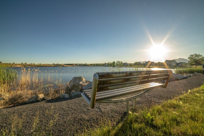 Empty Bench with a View of Scenic Lake Bright Sun and Cloudless Blue ...