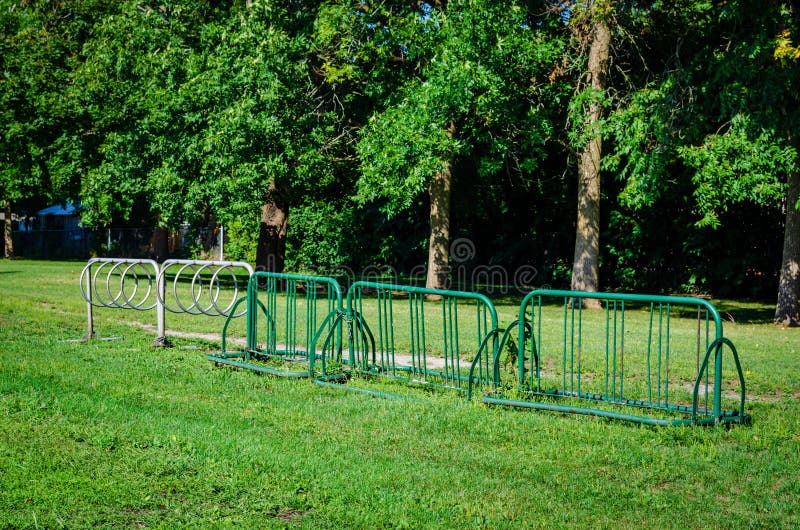 Empty Bicycle Racks in a Park Next To a Path Stock Image - Image of ...