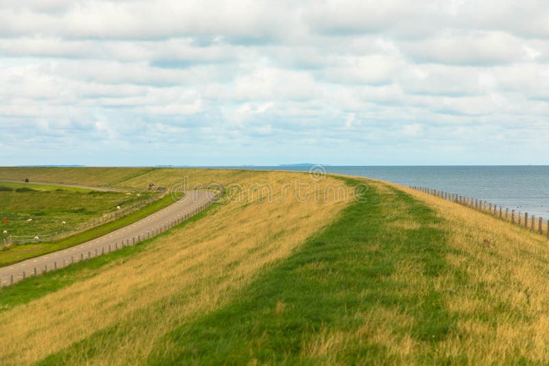 An Empty Bike Path Alongside a with Cumulus Clouds in the Background ...