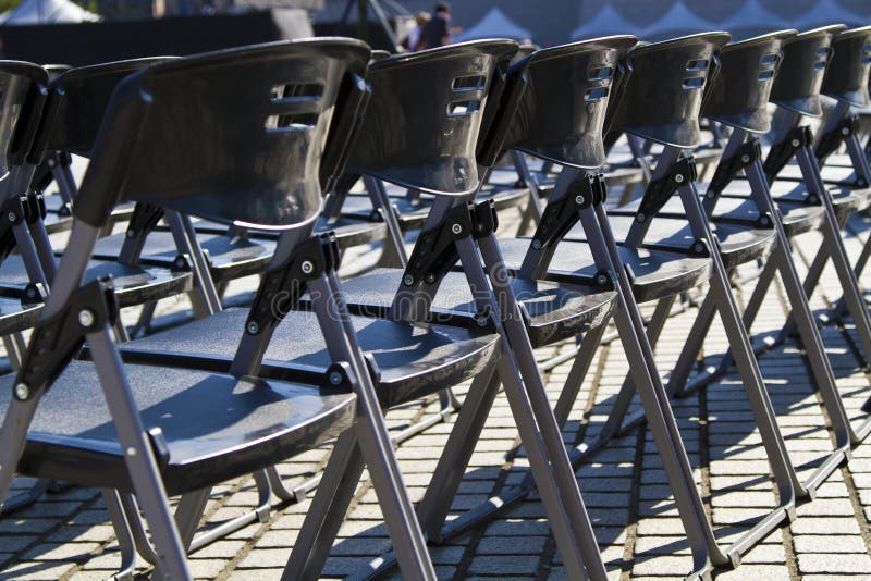 Empty black plastic chairs stock photo. Image of view - 38715442