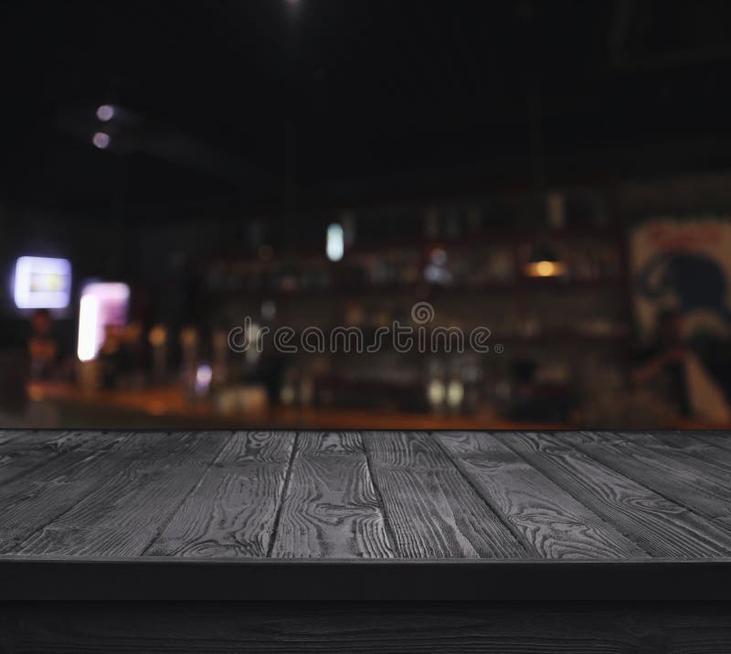 Empty Black Wooden Surface and Blurred View of Bar. Space for Design ...