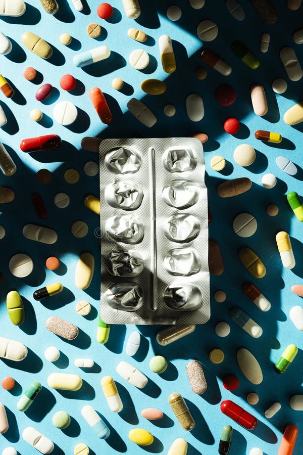 Empty Blister Pack on Blue Background Covered with Pills Stock Image ...