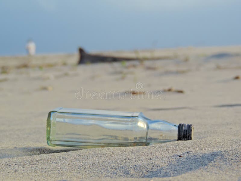 Empty bottle on the beach stock photo. Image of emptiness - 58610098