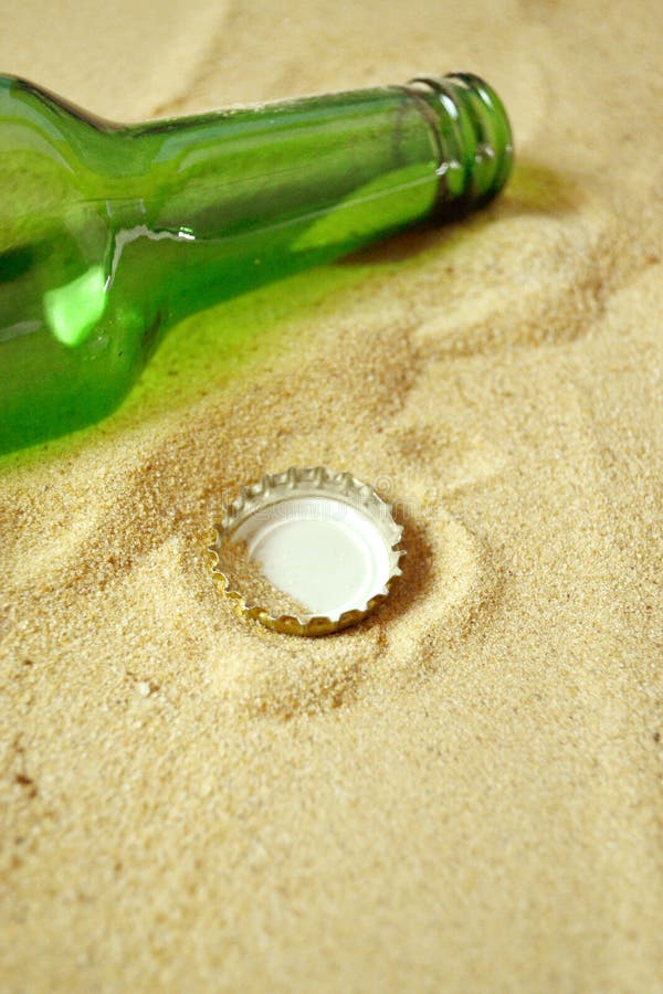 Empty Bottle with Cap Left on the Beach Stock Image - Image of crown ...