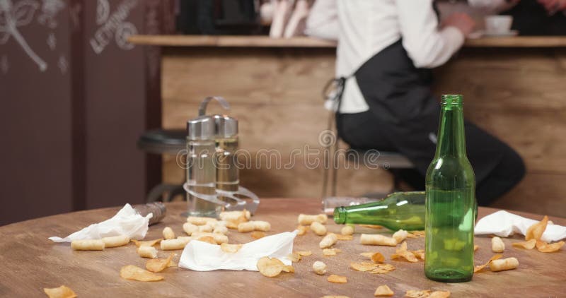 Empty Bottles on a Dirty Restaurant Table after Customers Left Stock ...