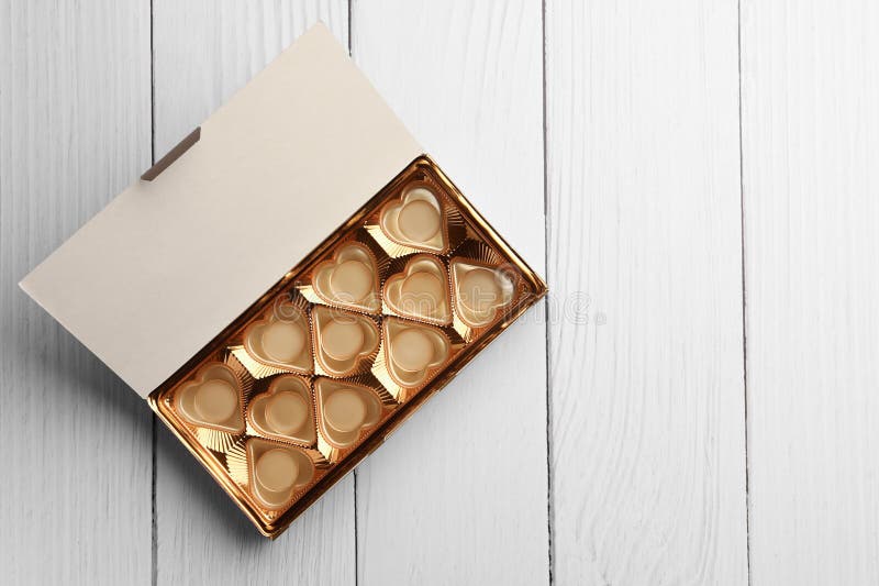 Empty Box of Chocolate Candies on White Wooden Table, Top View. Space ...