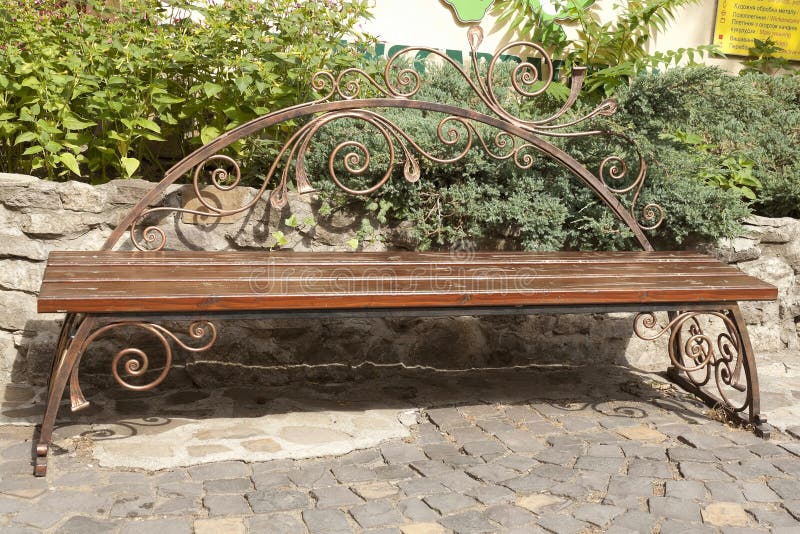 An Empty Brown Bench with Cast Metal Ornaments Stock Image - Image of ...