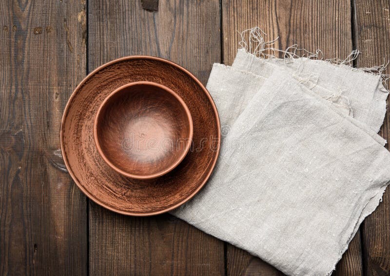 Empty Brown Ceramic Plates on a Wooden Table Stock Image - Image of ...