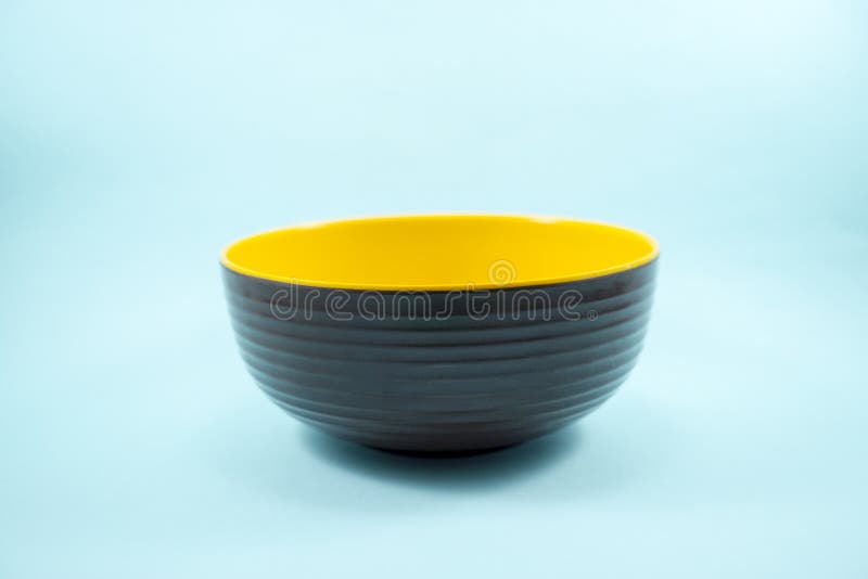 Empty Brown Plastic Bowl with Yellow Inside Isolated on Turquoise Stock ...