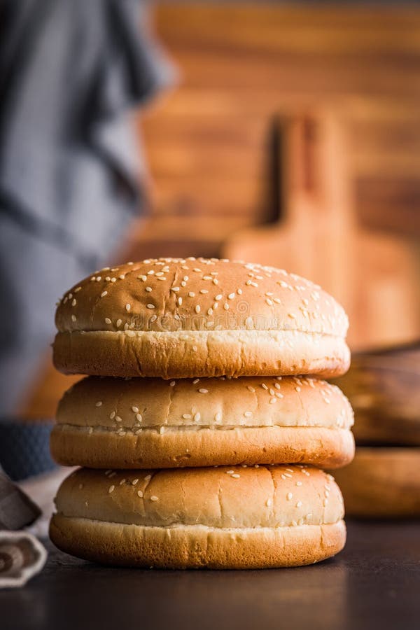 Empty Burger Bun with Sesame Seeds on Black Table Stock Image - Image ...