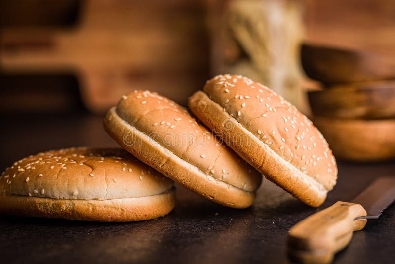 Empty Burger Bun with Sesame Seeds on Black Table Stock Image - Image ...